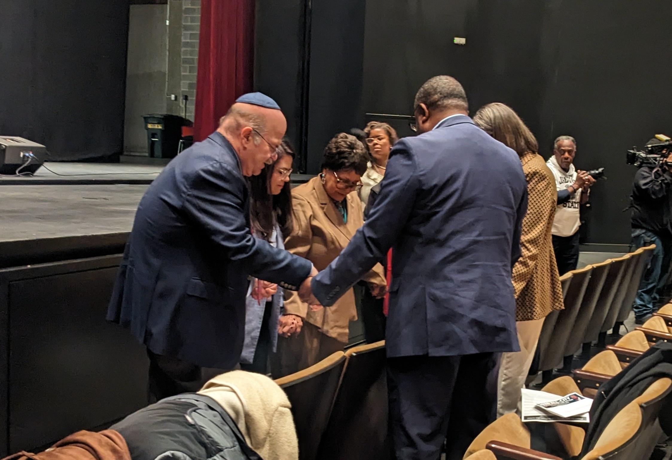 City officials and faith leaders stand by Beth Israel synagogue during ...