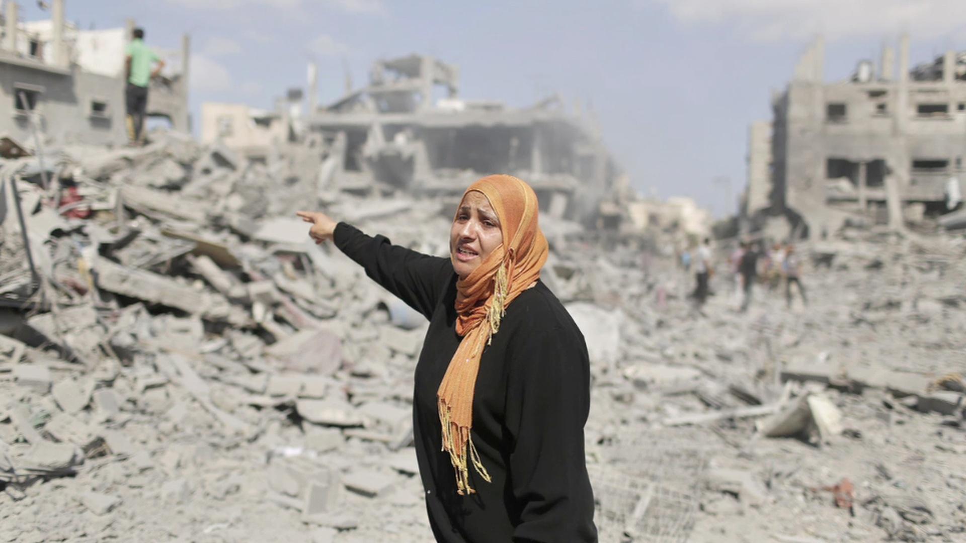 During cease-fire, Gaza residents survey destruction | PBS NewsHour ...